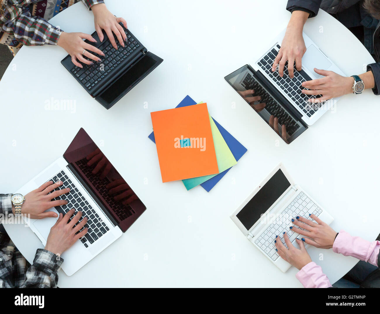 Top View of Rounded Desk with Four Laptops and People Hands Stock Photo ...