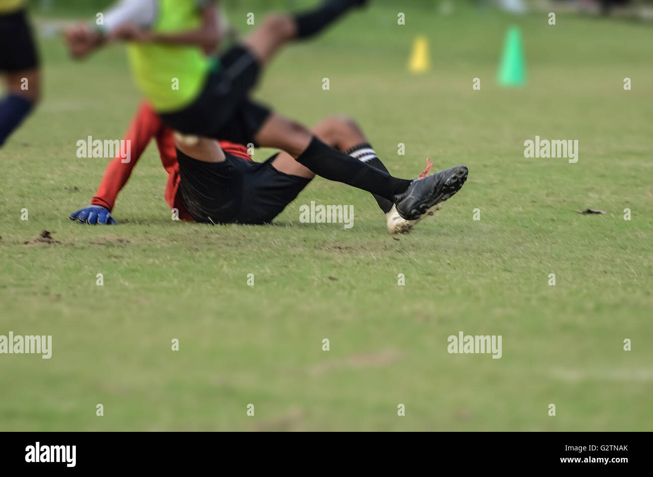 In play soccer goalkeeper laying down to defense attack. Boys are ...