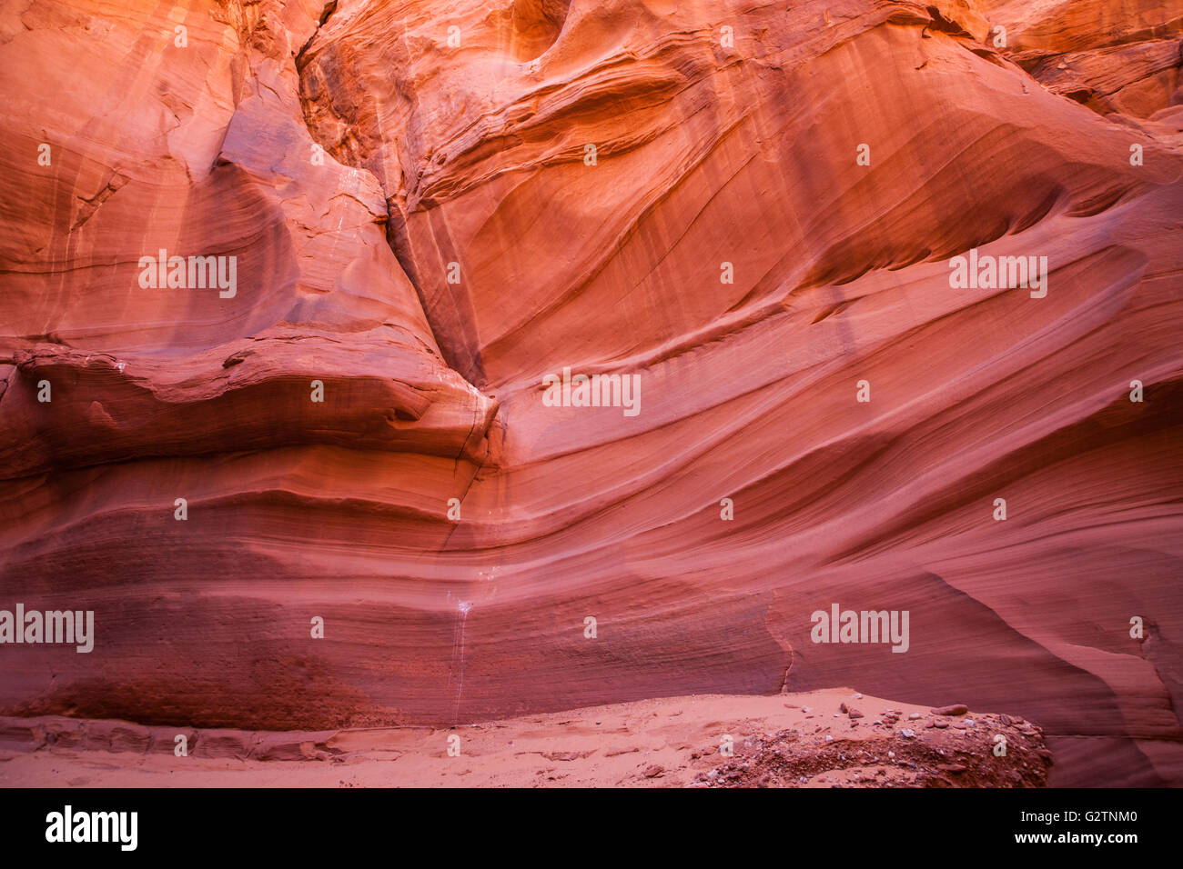 Warped rock patterns of orange sandstone walls in a slot canyon Stock ...