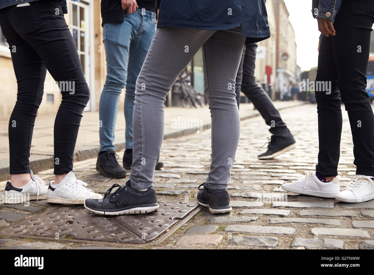 Group Of Teenagers Standing On Street In Urban Setting Stock Photo - Alamy