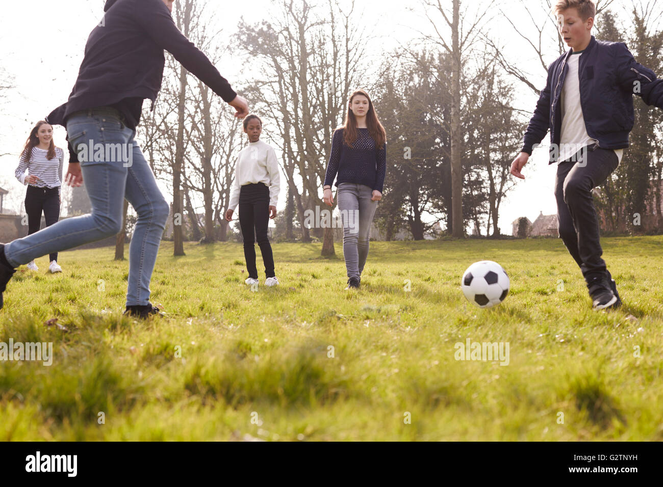 Group Of Teenagers Playing Soccer In Park Together Stock Photo - Alamy