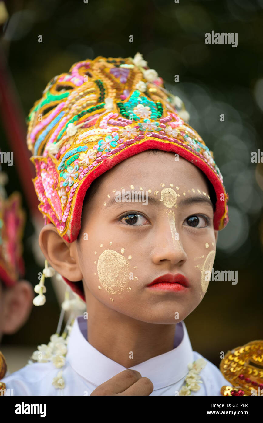 A boy during a shinbyu novitiation ceremony at Shwedagon Pagoda, Yangon ...