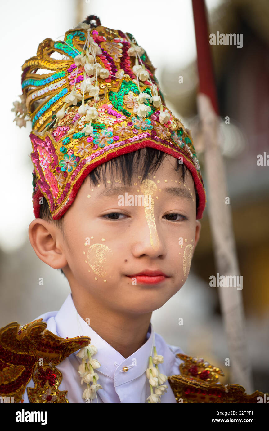 A boy during a shinbyu novitiation ceremony at Shwedagon Pagoda, Yangon ...