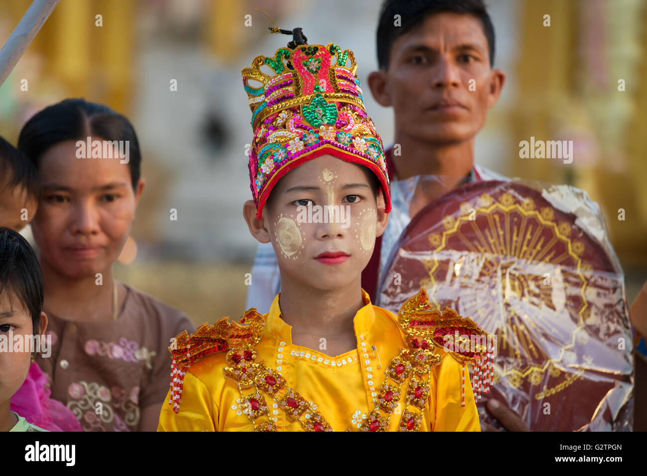 A boy and his relatives during a shinbyu novitiation ceremony at ...