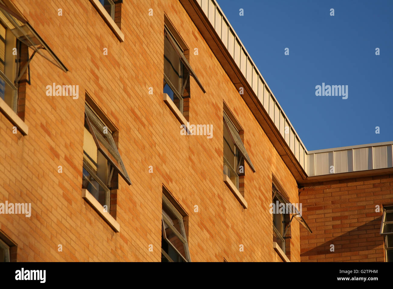 Brick building with open windows Stock Photo - Alamy