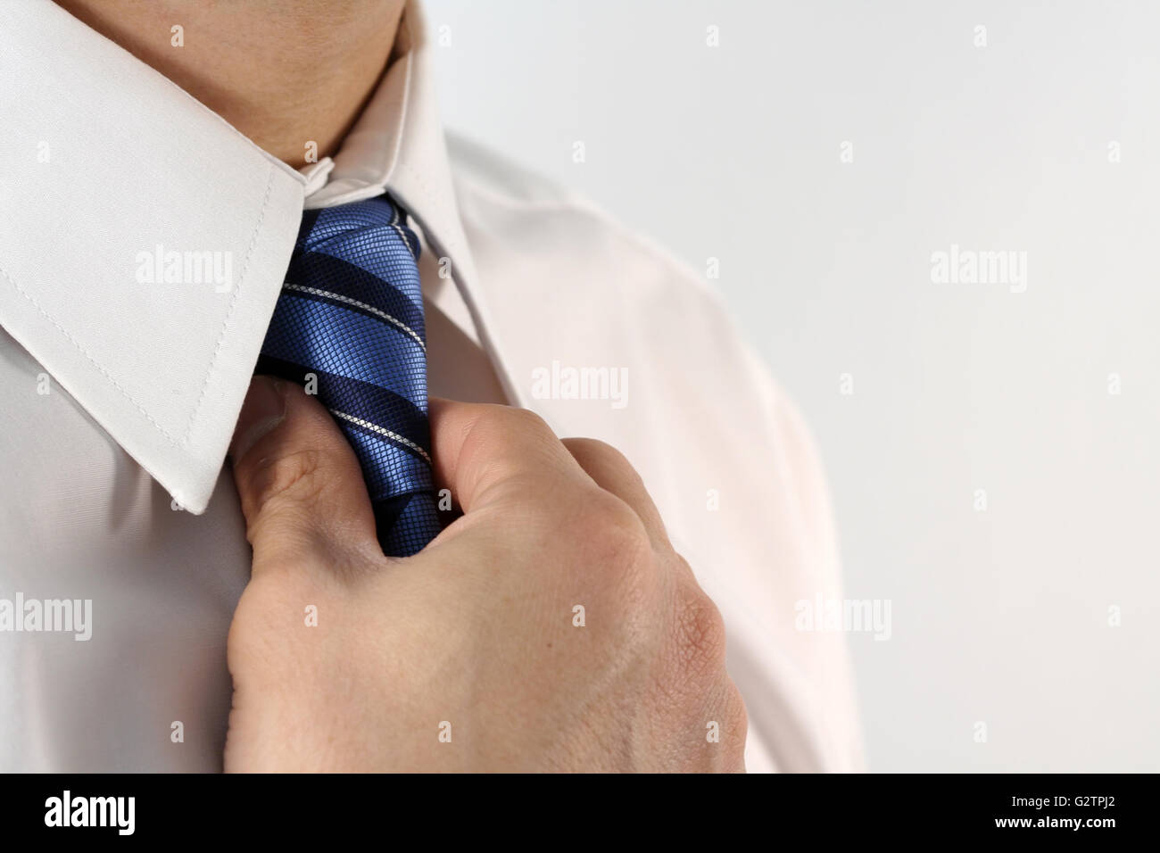 Business man tying a tie Stock Photo - Alamy