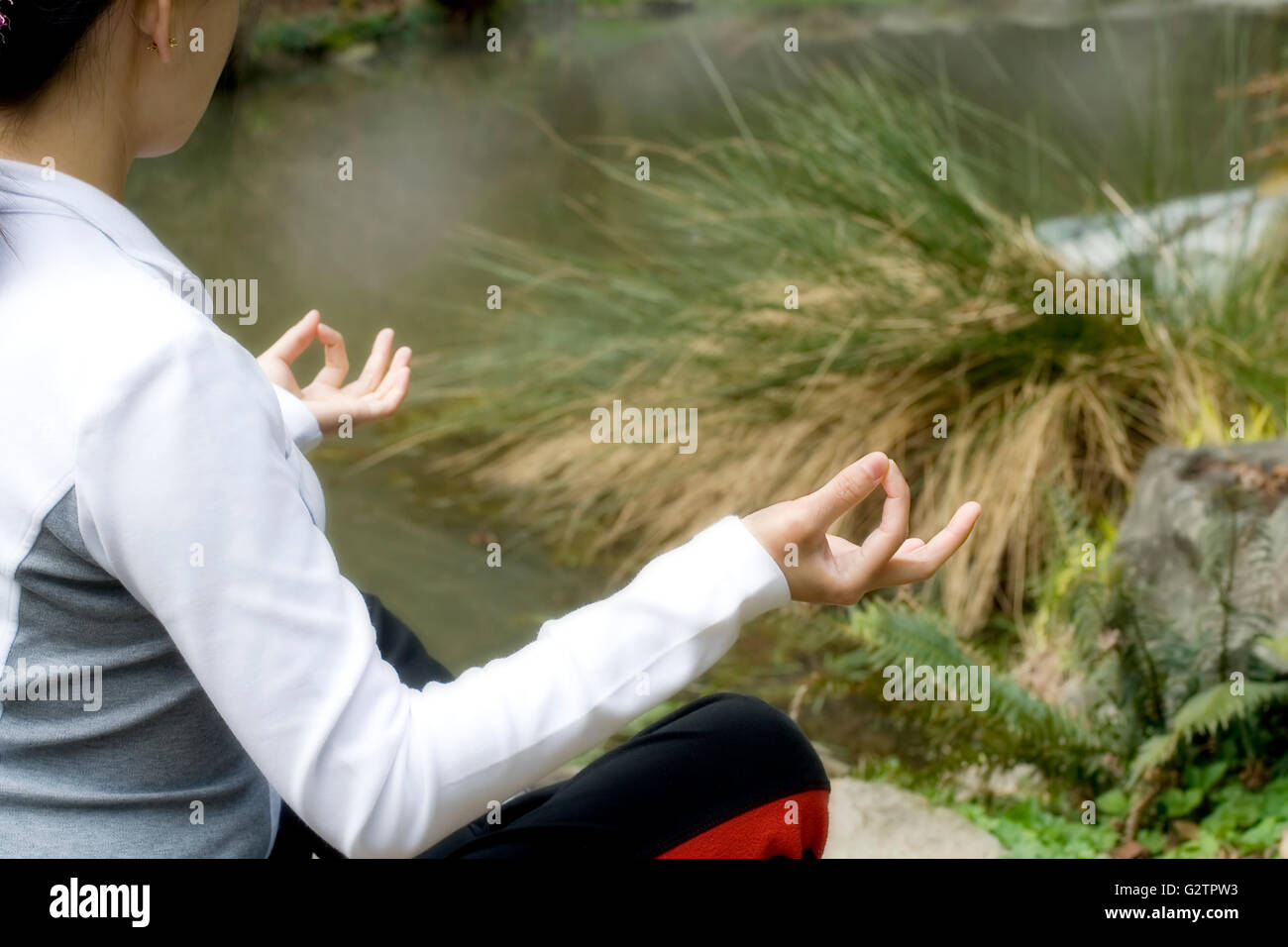 Woman relaxing by meditation/yoga Stock Photo - Alamy