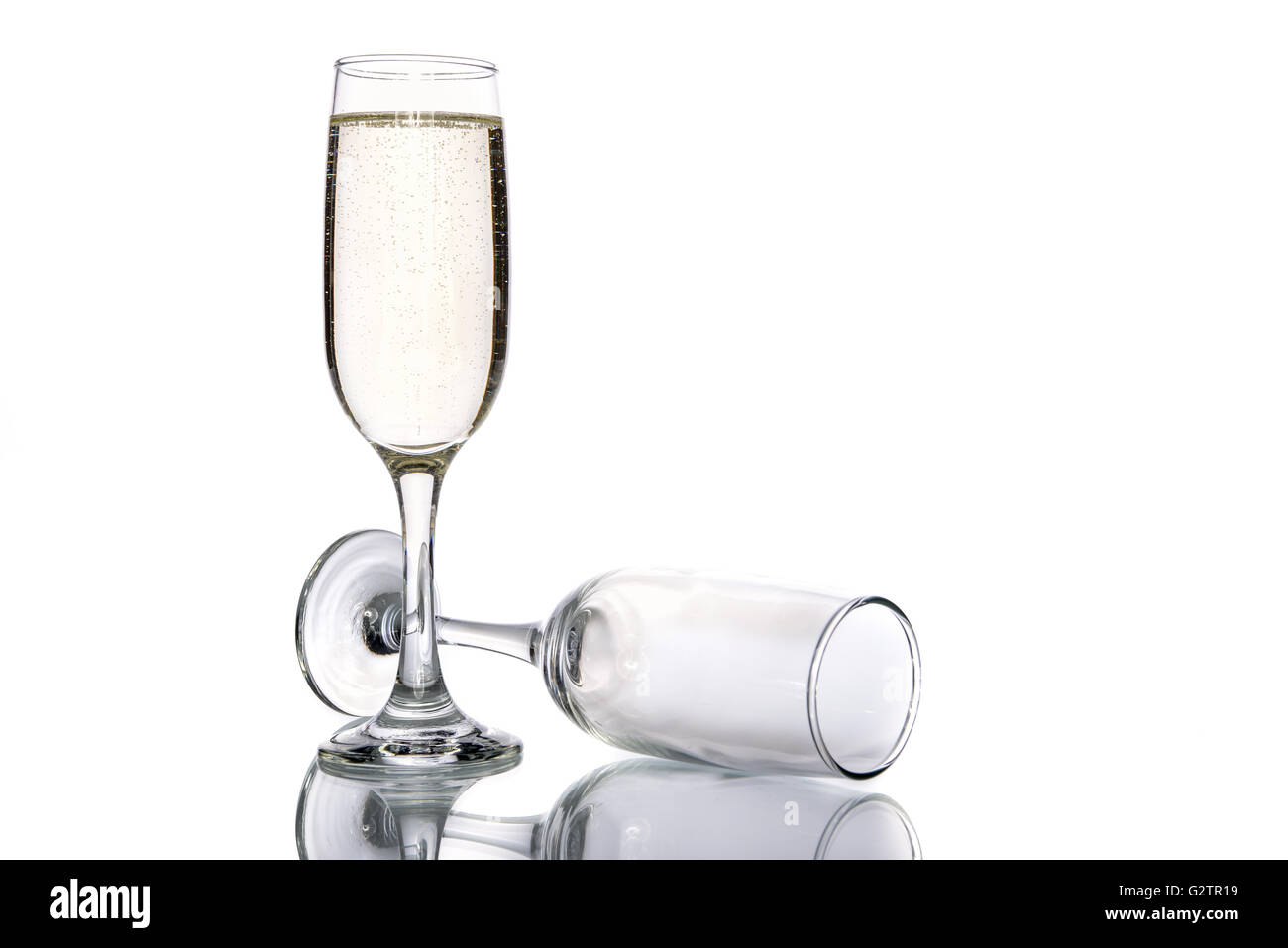 Glass of champagne and empty champagne glass on white background Stock ...