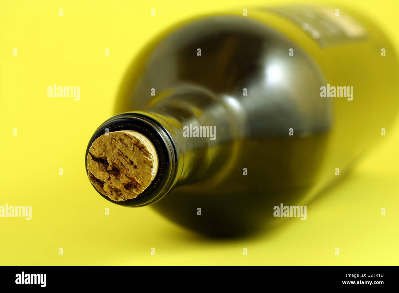 Wine bottle with yellow background Stock Photo - Alamy
