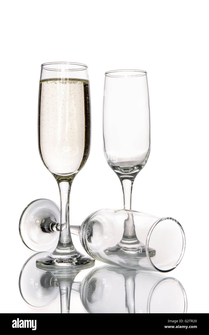 Glass of champagne and empty champagne glass on white background Stock ...