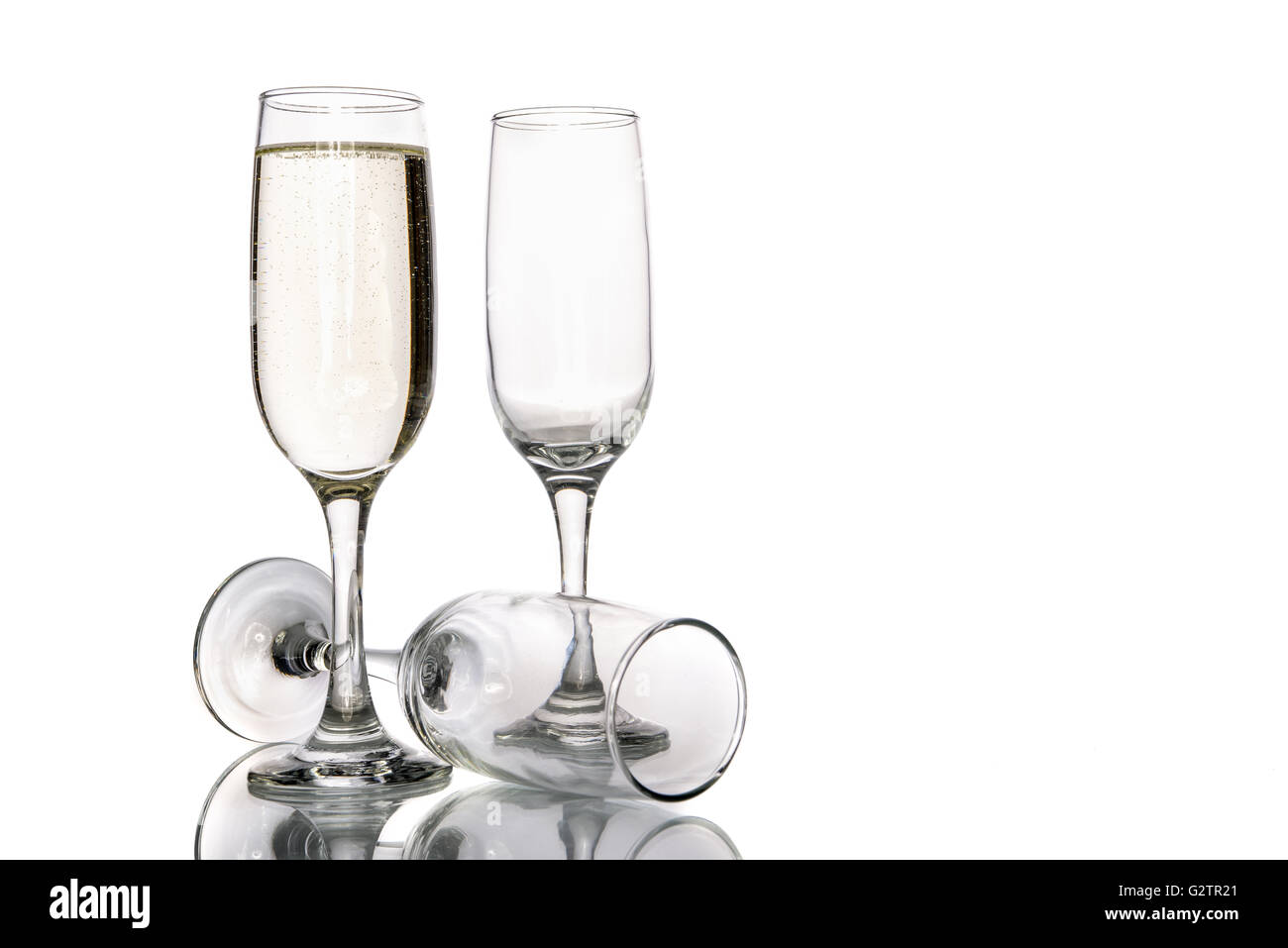 Glass of champagne and empty champagne glass on white background Stock ...