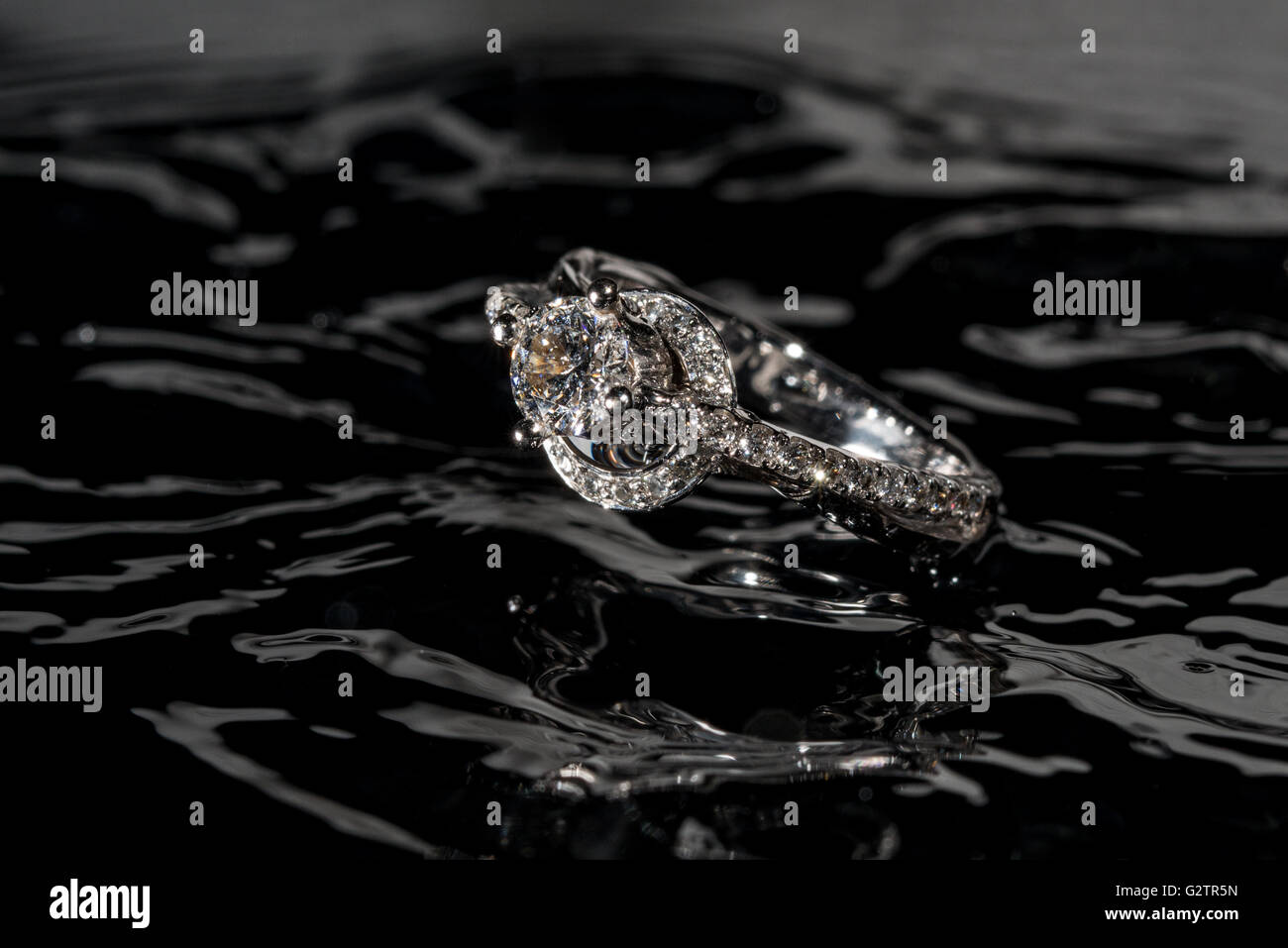 Diamond engagement ring floating in the water, closeup Stock Photo - Alamy
