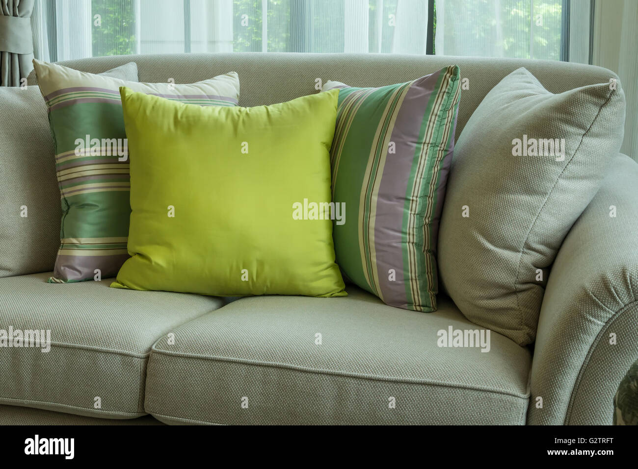 green pillows on modern sofa in living room Stock Photo - Alamy