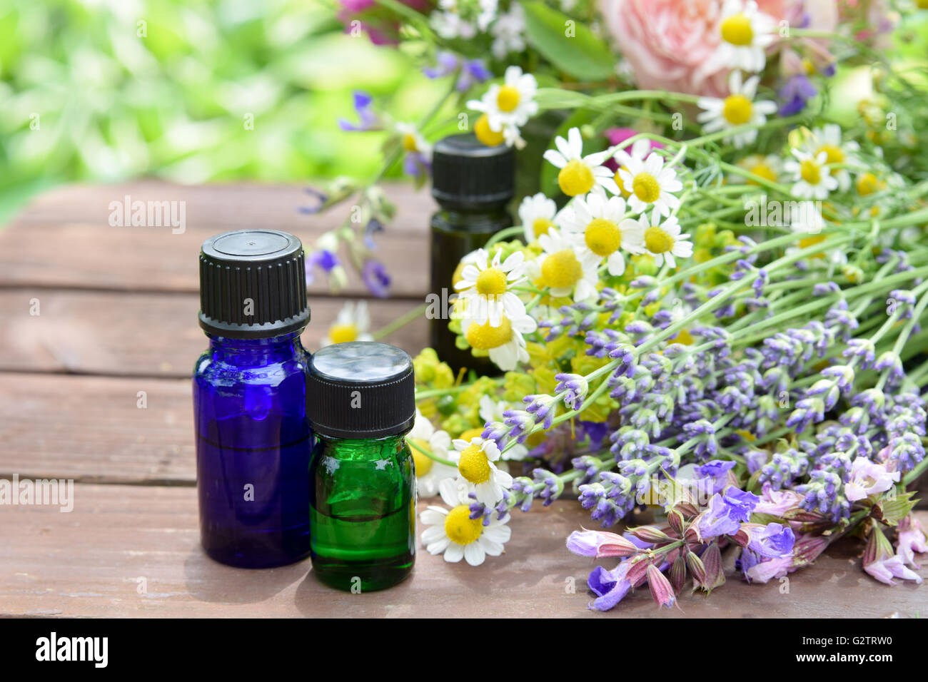 essential oils with herbal flowers Stock Photo - Alamy
