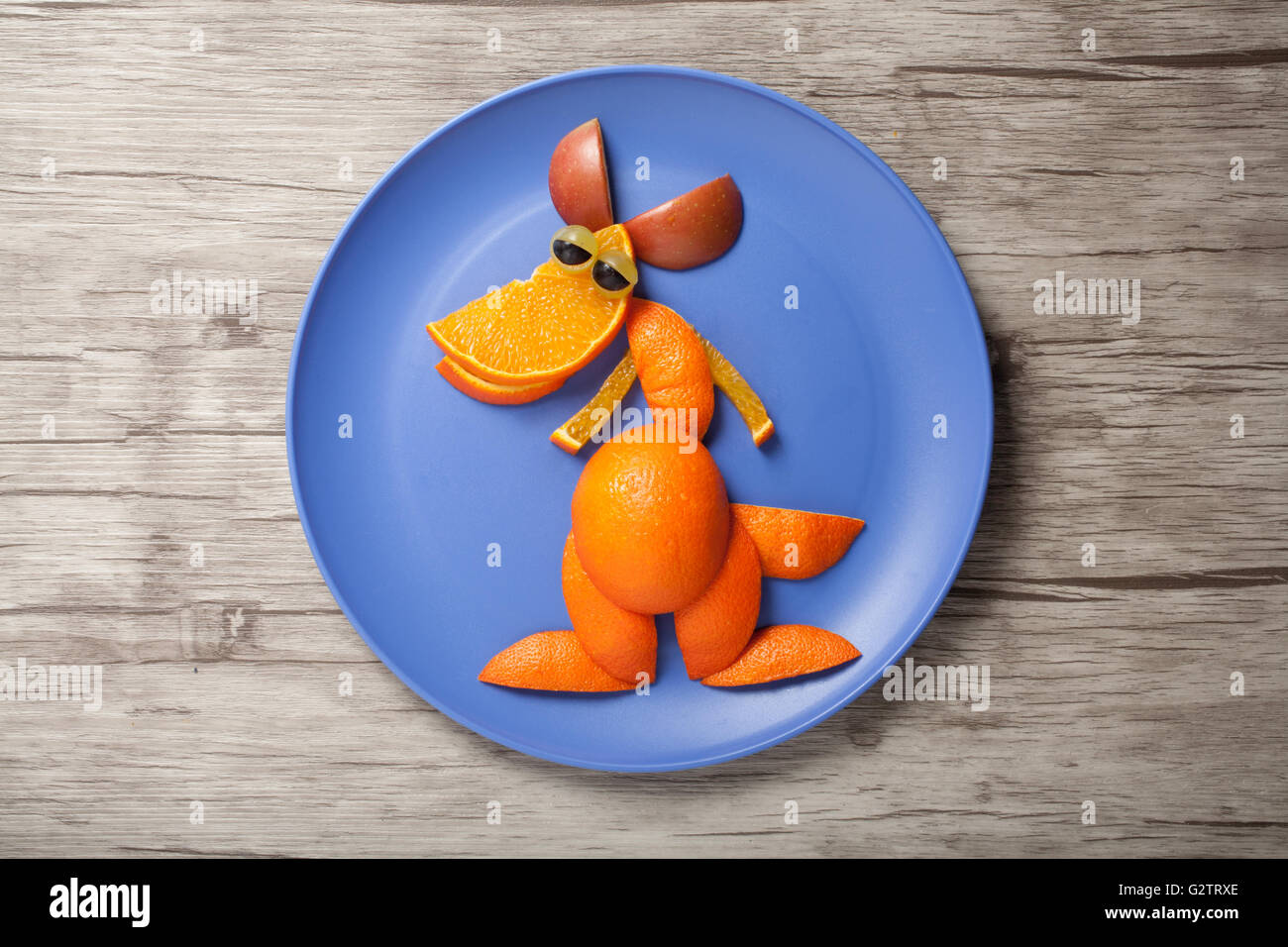 Kangaroo made of orange on plate and wood Stock Photo - Alamy