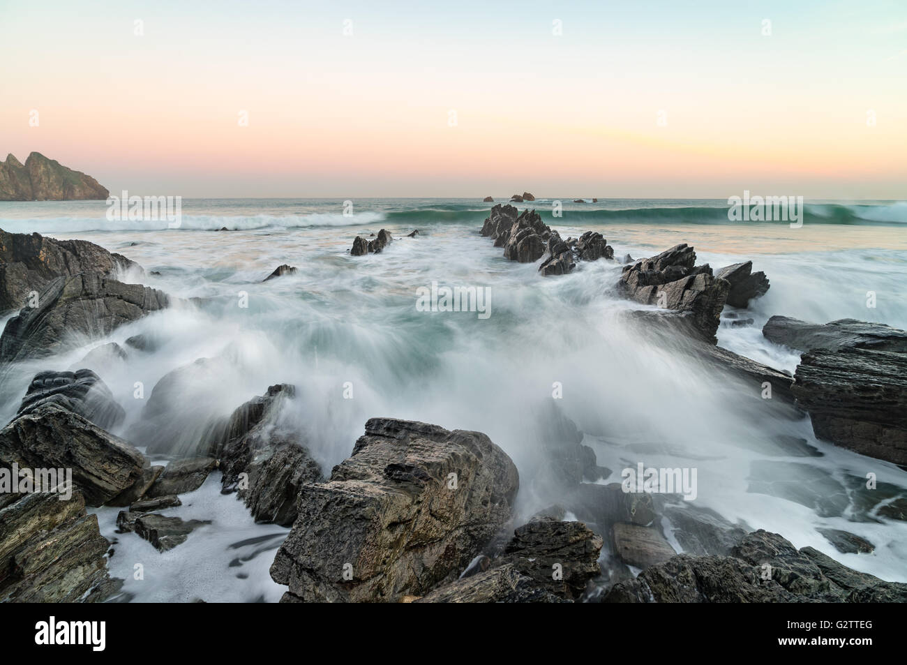 Waves hitting the beach at the Atlantic coast of Spain. Sunrise at the ...