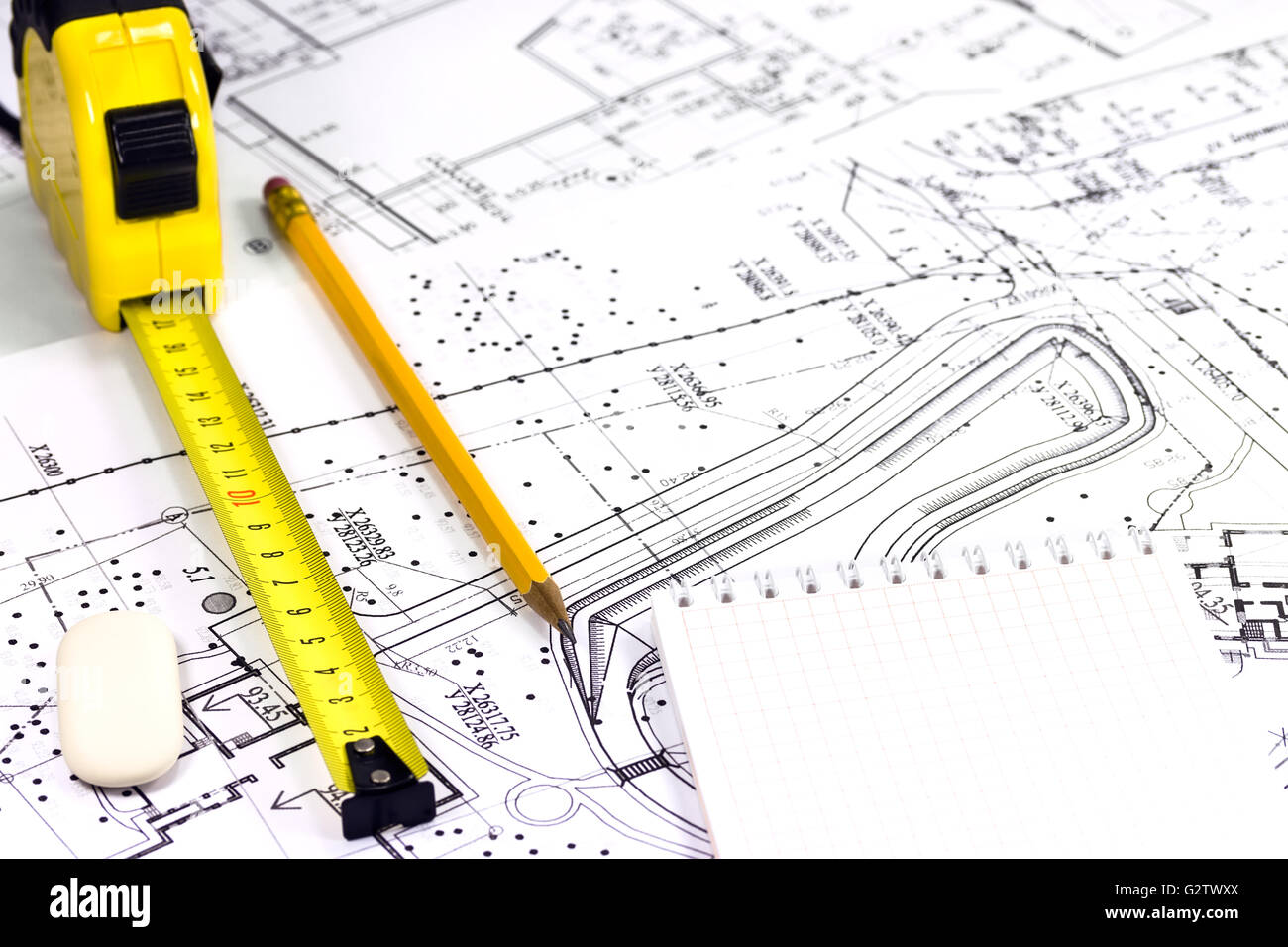 Home building construction plans with yellow measuring tape Stock Photo ...