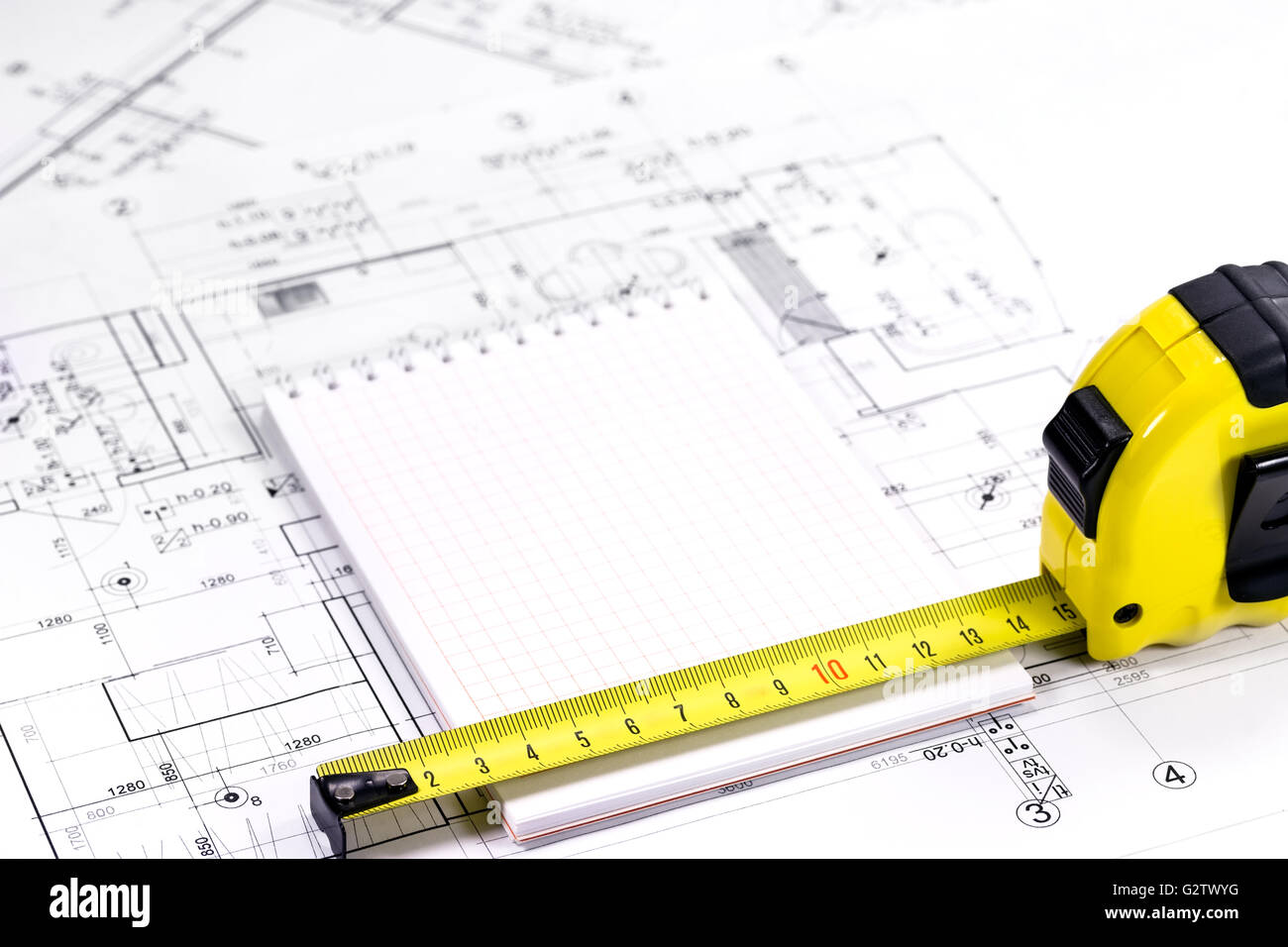 Home building construction plans with yellow measuring tape Stock Photo ...