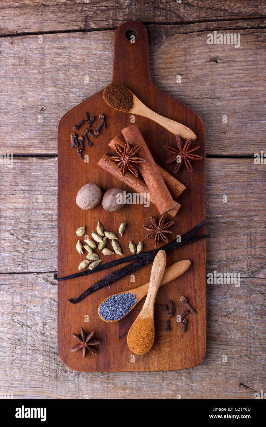 Variety of spices for baking on cutting board, background Stock Photo ...