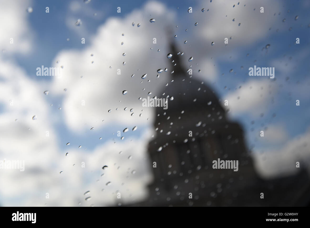 Looking through raindrops on a pane of glass to an unfocused St Paul's ...