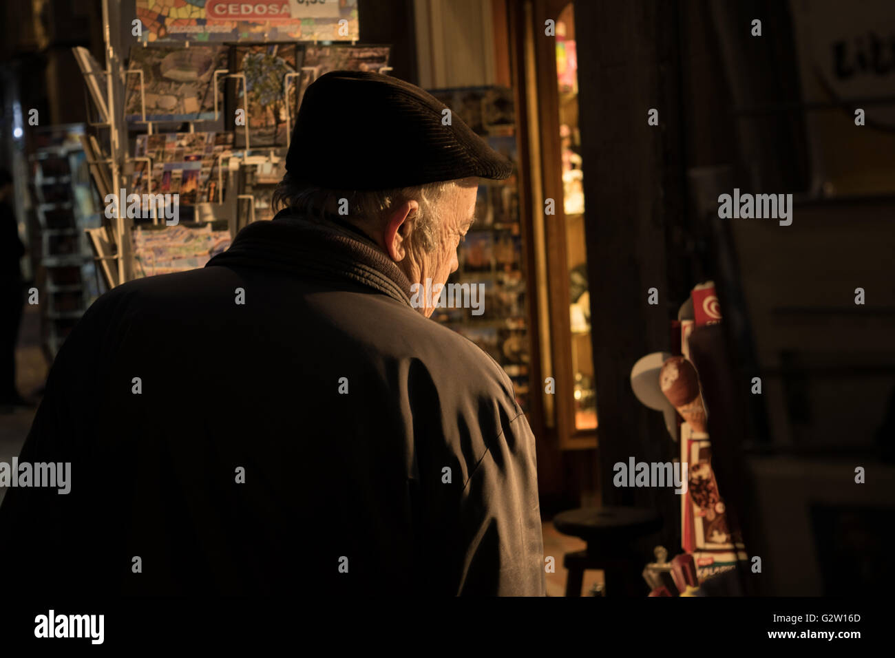 Old man looking at magazines in Barcelona, Spain Stock Photo - Alamy