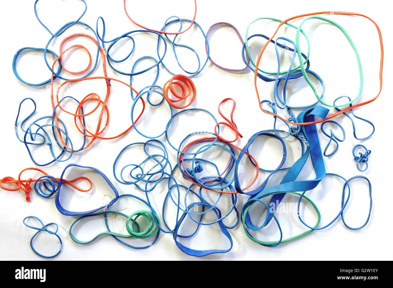 A pile of red, blue and green elastic bands photographed against a ...