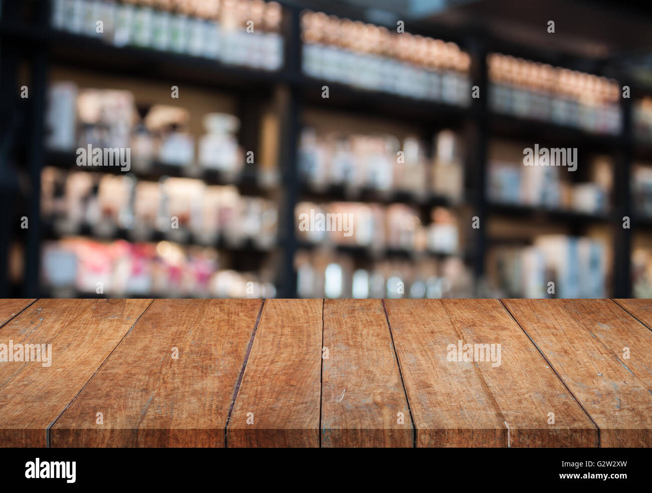 Perspective top wooden table with blurred cafe background. product ...