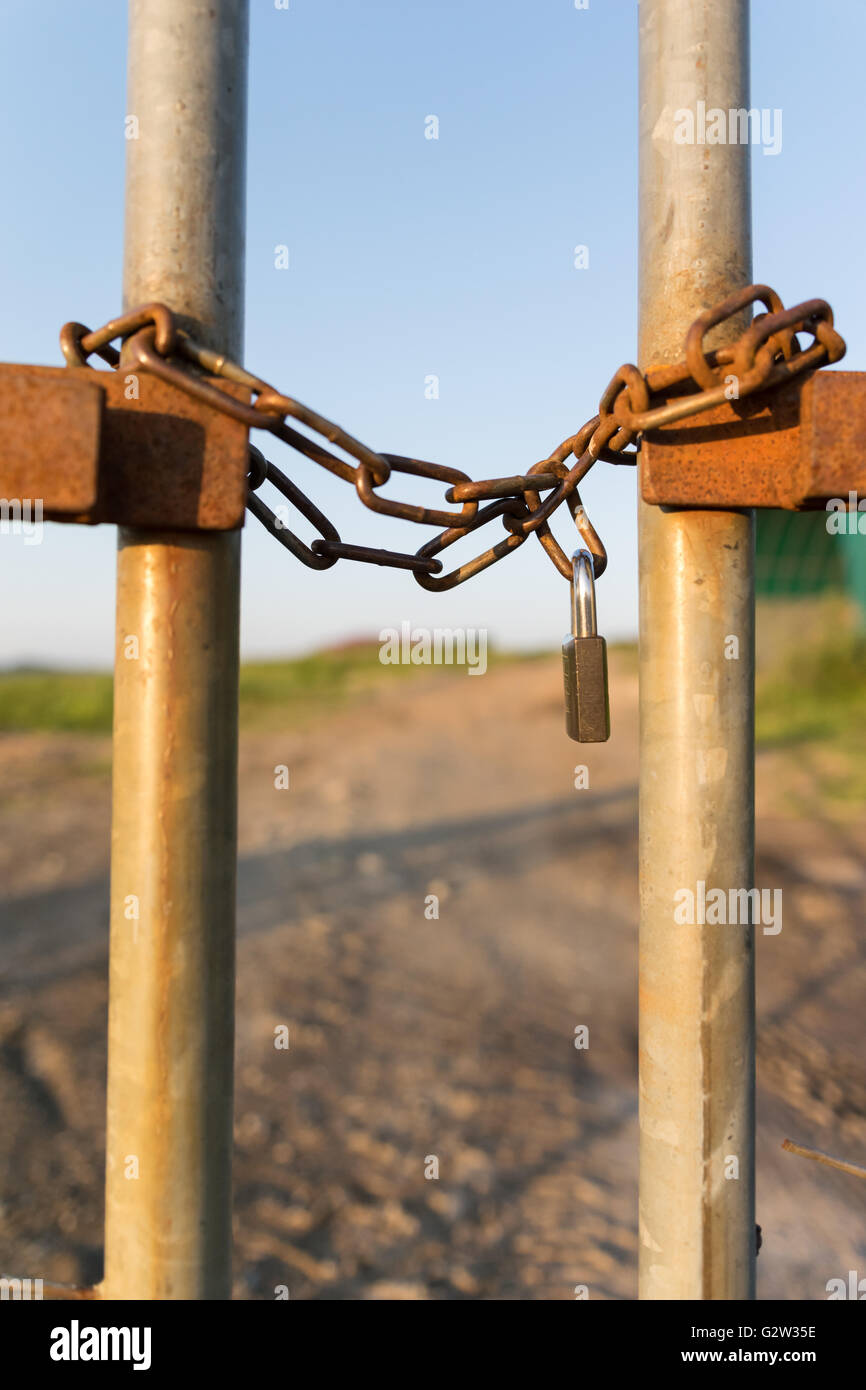 Fence locked chain vertical Stock Photo - Alamy
