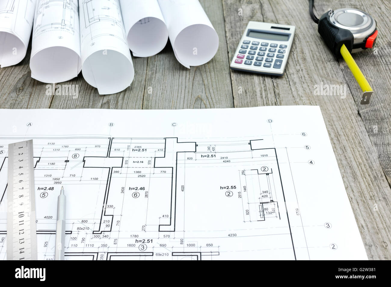 contractor workspace with floor plan and tools on wooden desk Stock ...