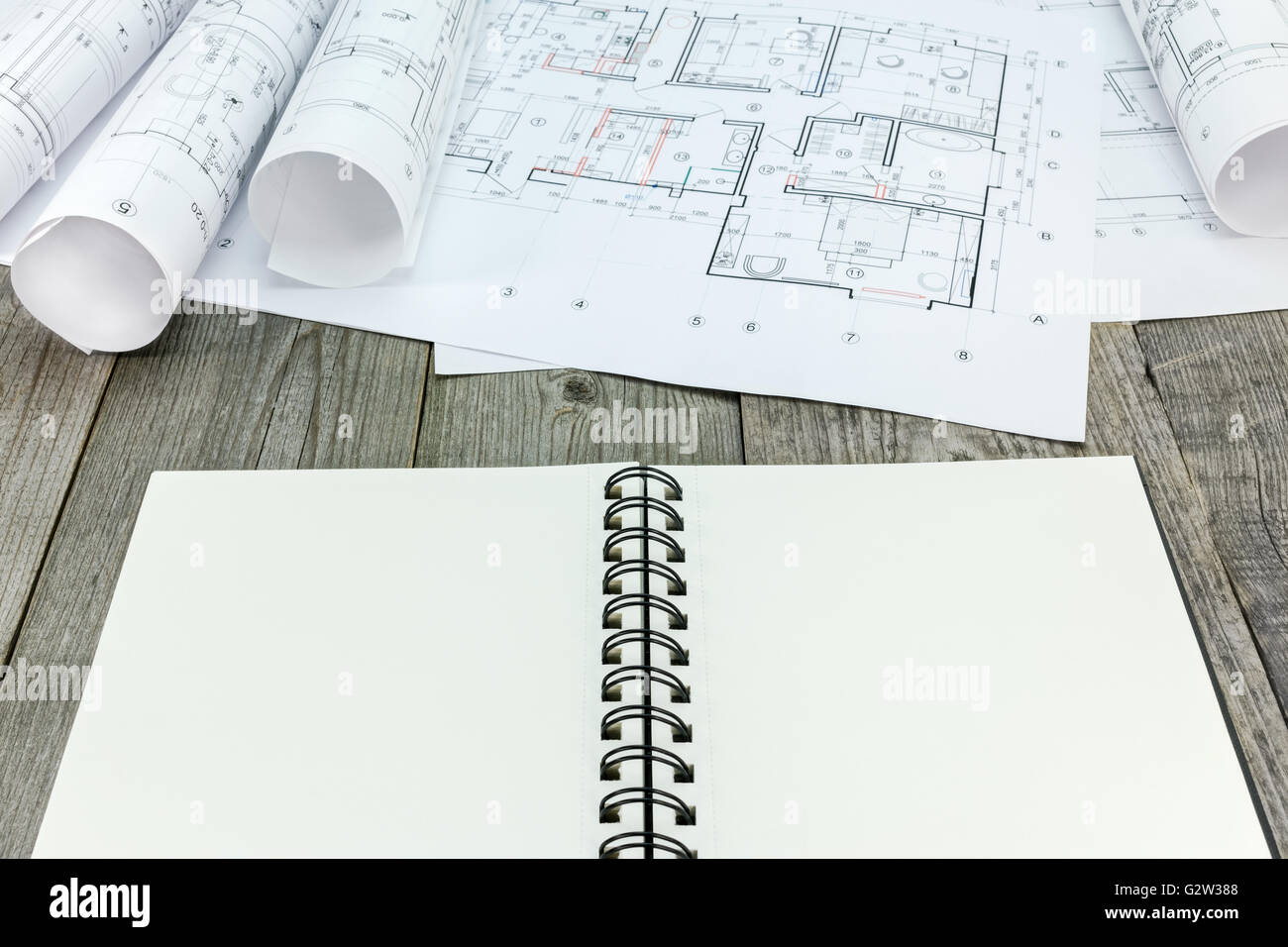 notepad with rolls of architectural blueprints and technical drawings ...
