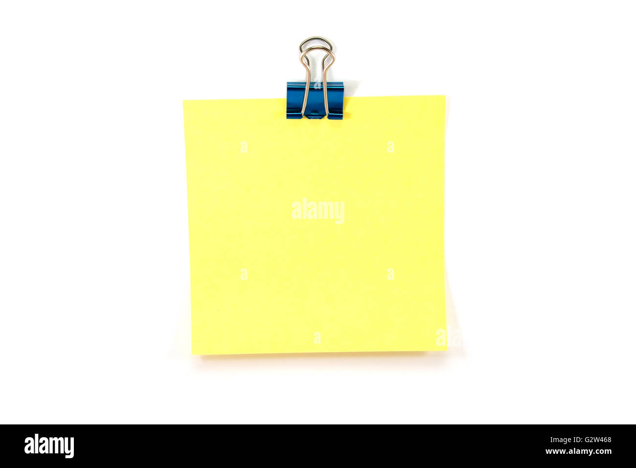 Yellow note with a binder clip, Isolated on white Stock Photo - Alamy