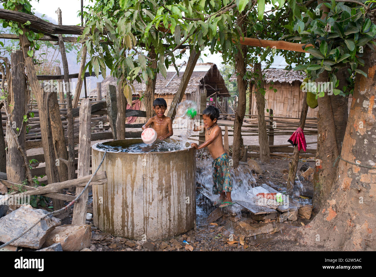 Two Lishaw (Lisu) young boys playing with water, Kayan State, Myanmar ...