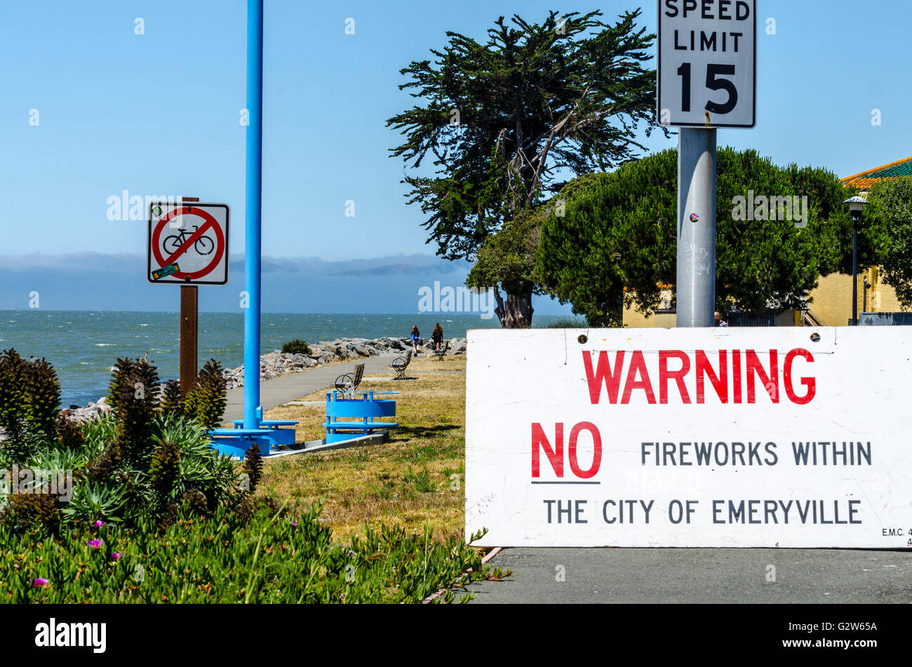 A trio of warning signs on Powell Street in Emeryville California with ...