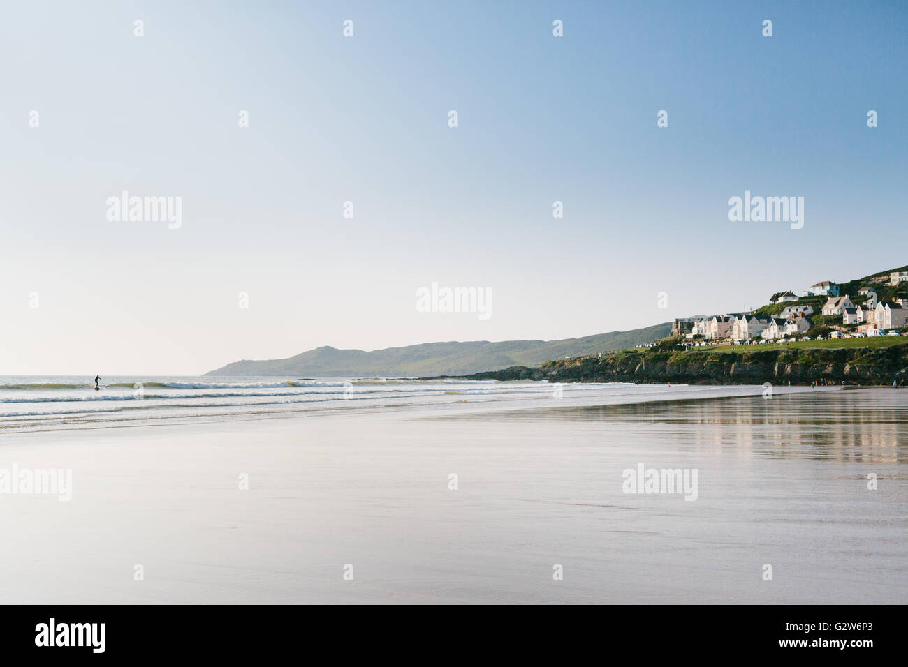 A surfer rides a wave at Woolacombe Beach, Devon Stock Photo - Alamy
