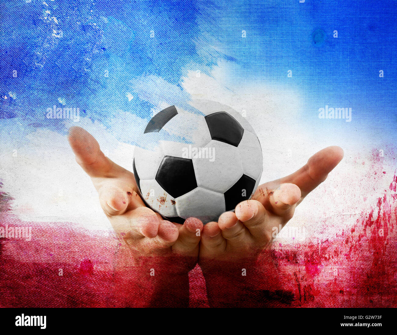 Soccer ball in the hands of a man on red,blue, and white background ...