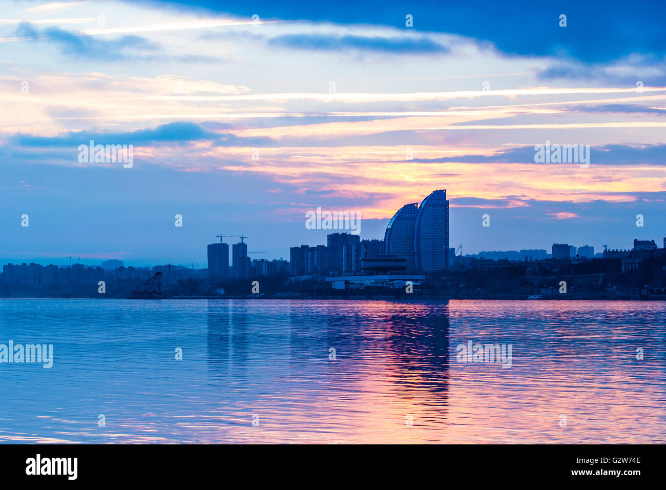 Reflection of urban architecture in the river at sunset Stock Photo - Alamy