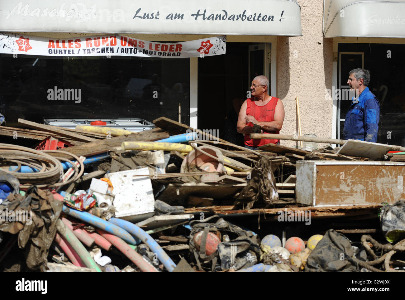 Bavaria, Germany. 04th June, 2016. Two men stand behind a pile of mud ...