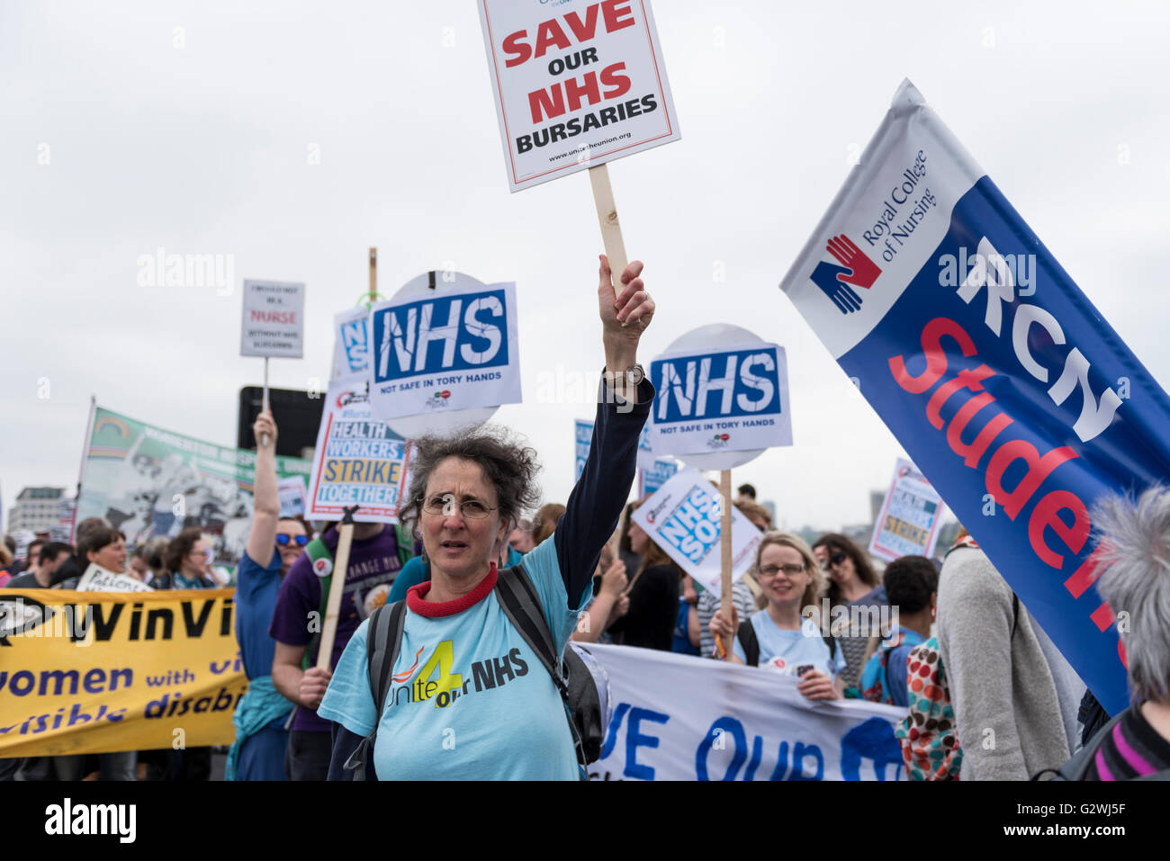 London, UK. 4 June 2016. NHS nurses march across Waterloo Bridge, in ...