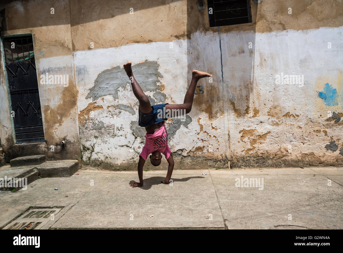 Boy, Salvador, Bahia, Brazil, handstand, favela, poverty, playing ...