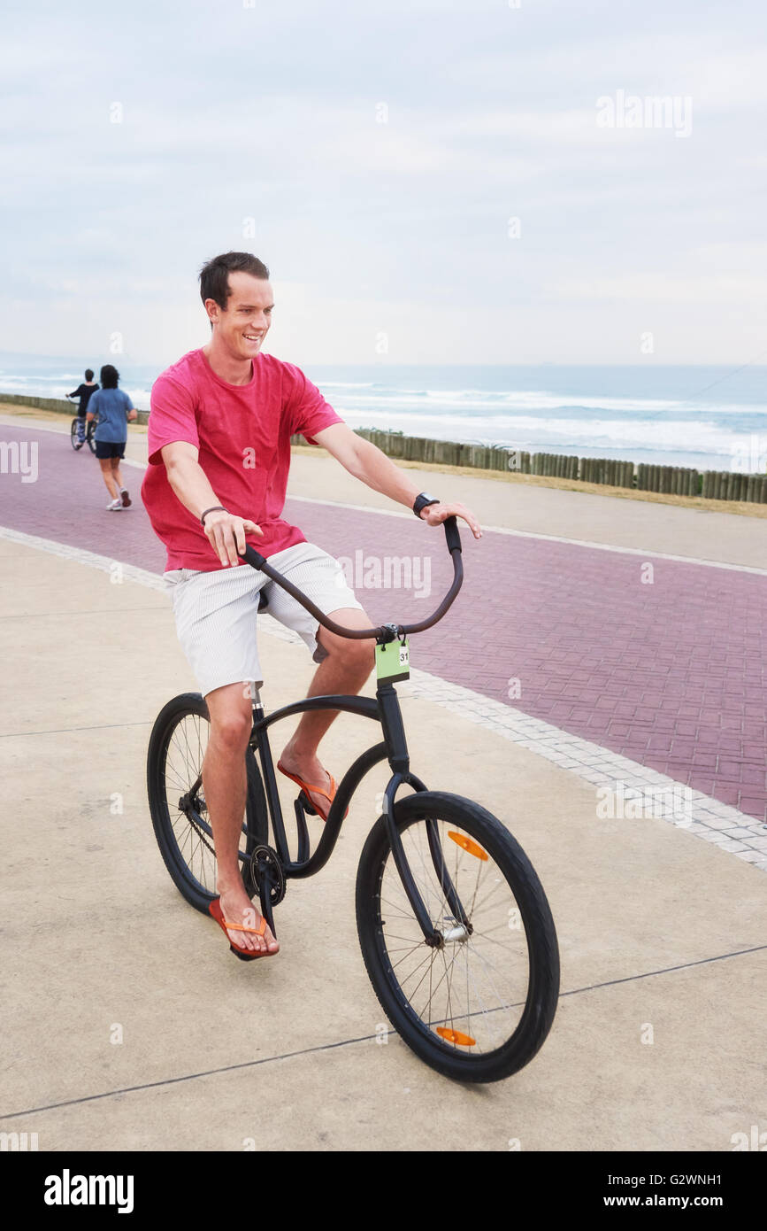 Young adult male riding his bicycle outdoors Stock Photo - Alamy
