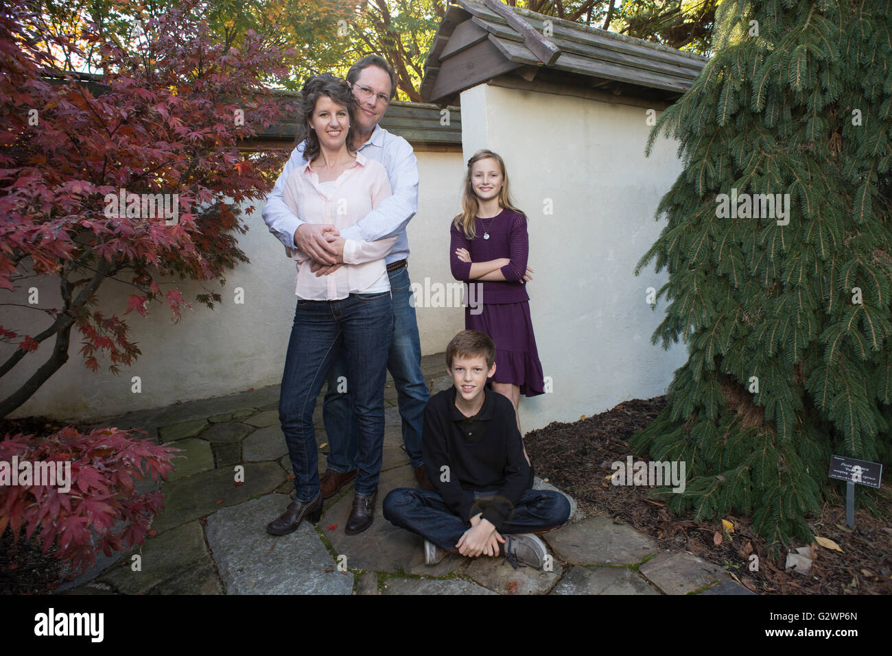 A Caucasian family of four pose for photographs at JC Arboretum in ...