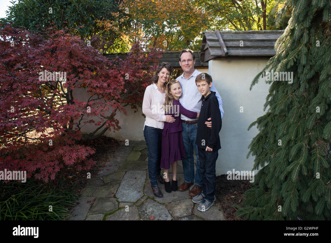 A Caucasian family of four pose for photographs at JC Arboretum in ...