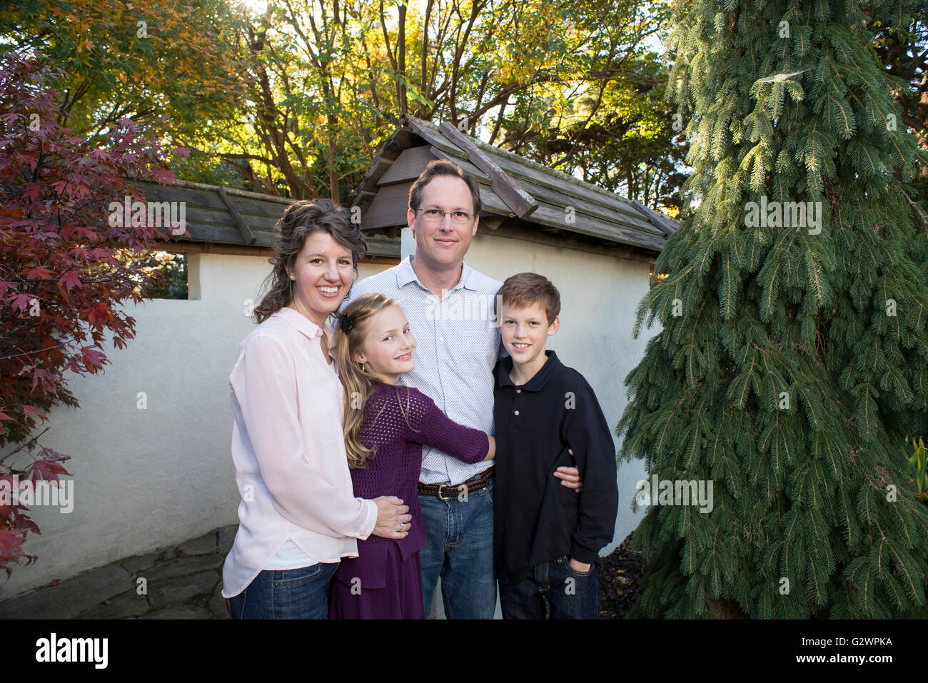 A Caucasian family of four pose for photographs at JC Arboretum in ...