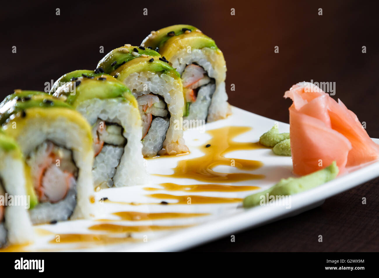 beautiful sushi roll topped with avocado stuffed with crab meat ...
