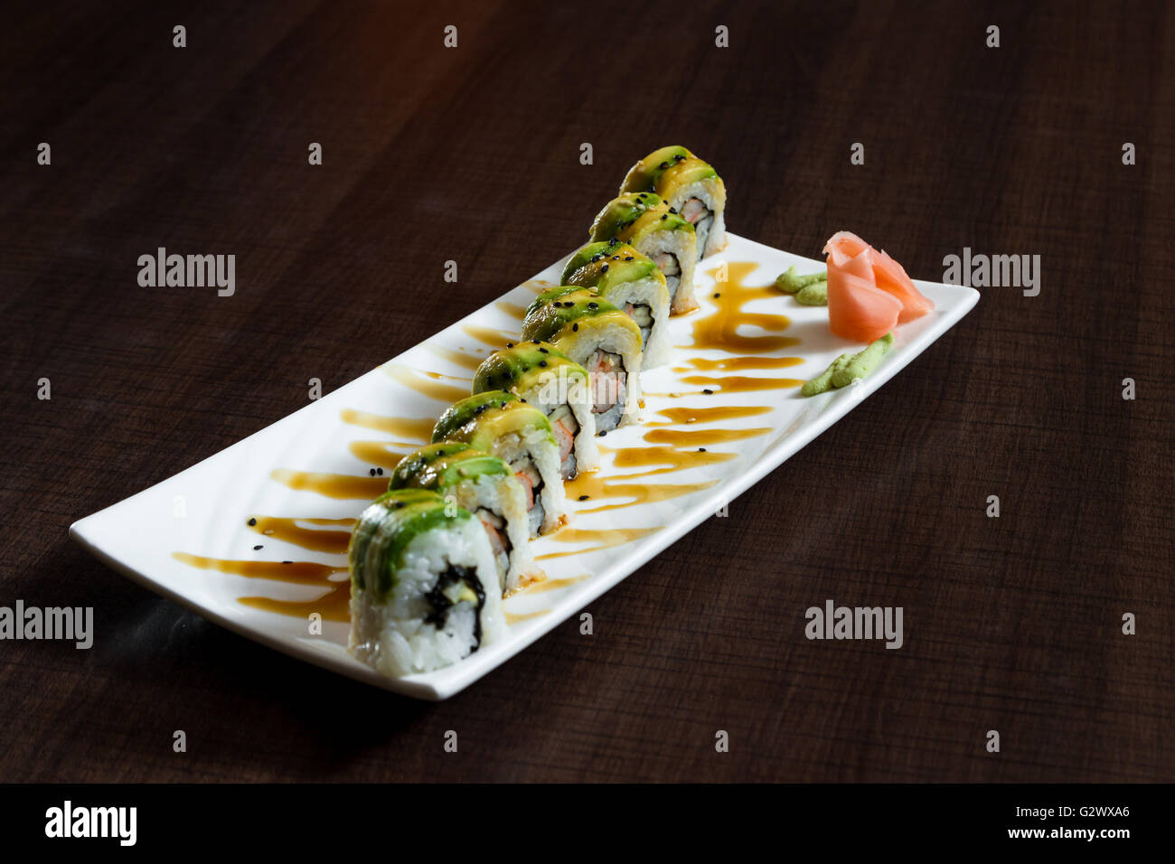 beautiful sushi roll topped with avocado stuffed with crab meat ...