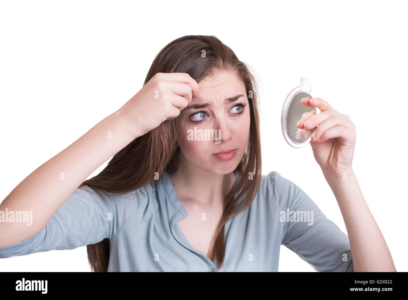 Woman looking at the first grey hair on her scalp Stock Photo - Alamy