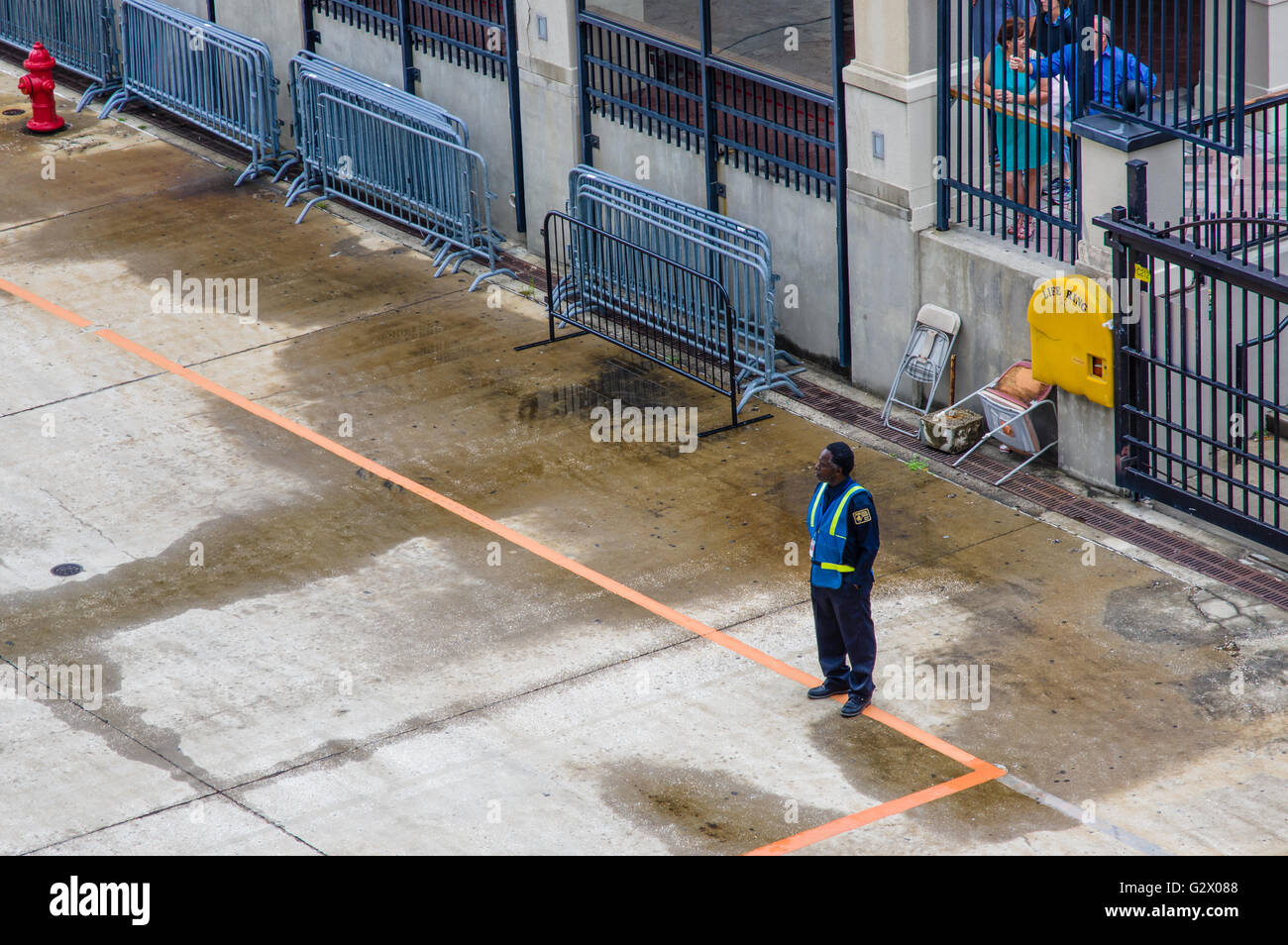 A security guard watches a cruise ship being loaded at the Tampa Bay ...