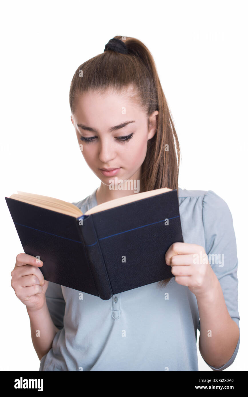 Young beautiful girl reading a book and thinking Stock Photo - Alamy