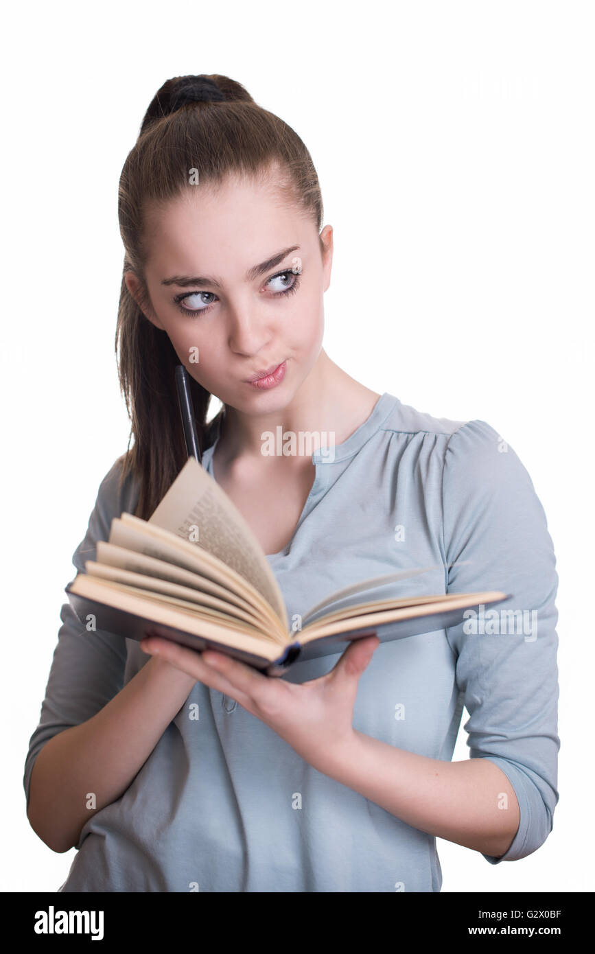 Young beautiful girl reading a book and thinking Stock Photo - Alamy