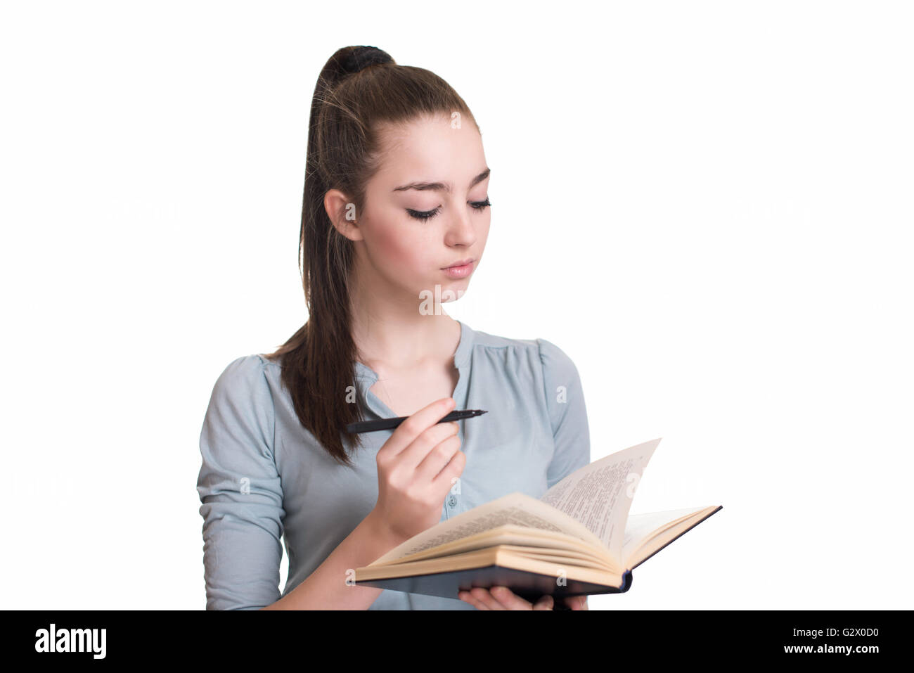 Young beautiful girl reading a book and thinking Stock Photo - Alamy